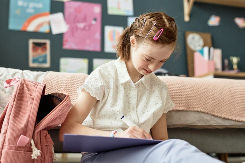 Young Student Concentrating on Homework in Cozy Study Space Stock Photo ...