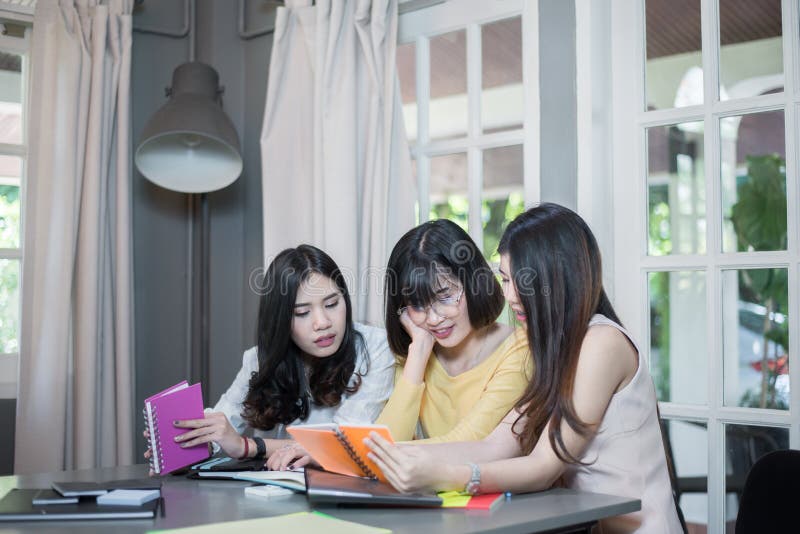 Young Student Discussing Things and Working with Labtop or Notebook on ...