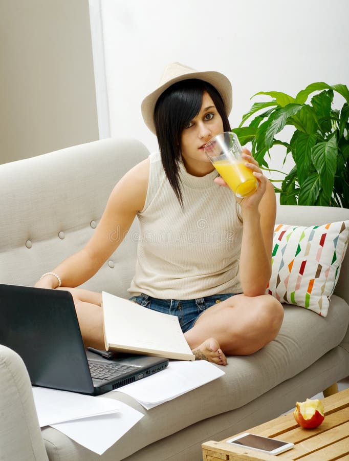 Young Student Drinking Orange Juice in Couch Stock Photo - Image of ...