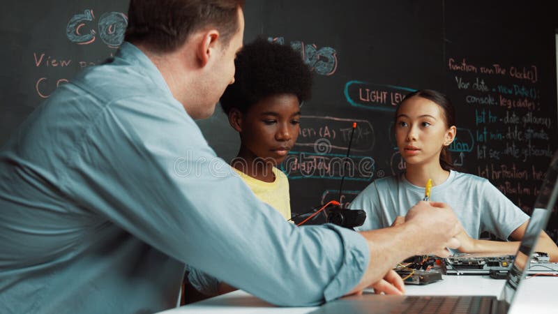 Young Student Fixing Controller while Teacher Pick Electronic Tool ...