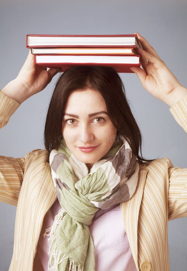 Young Student Girl Balancing Books on Her Head (Education and Se Stock ...