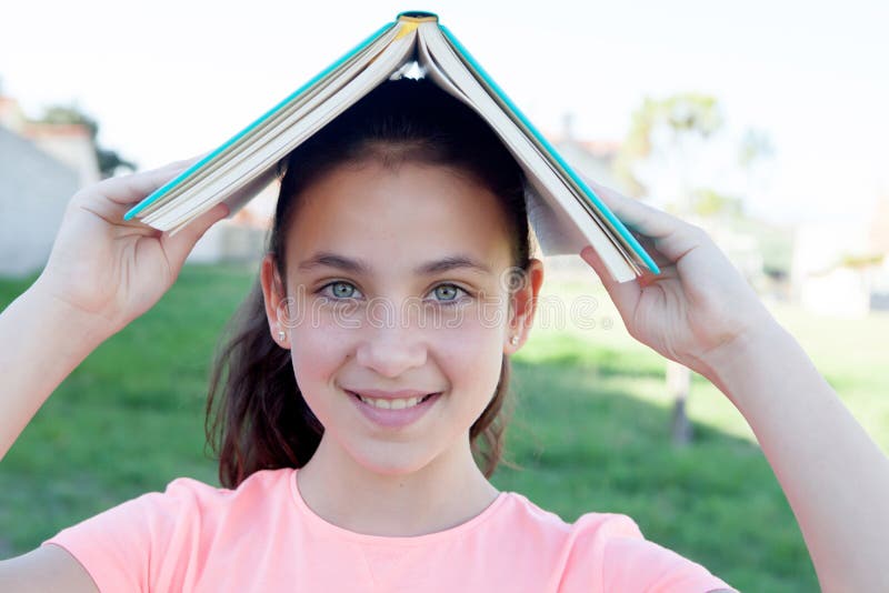 Young Student Girl with a Book on the Head Stock Image - Image of ...
