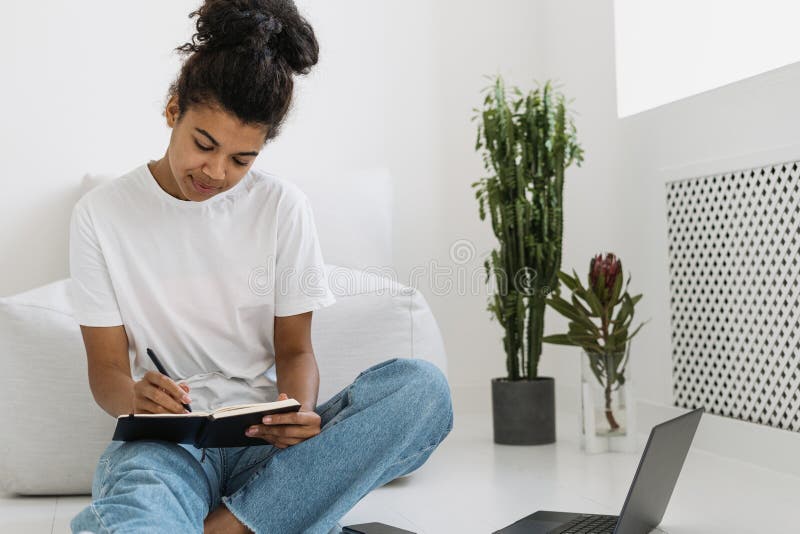 Young Student Girl Writing Notes in Her Notepad Stock Photo - Image of ...