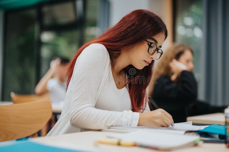 Focused Students Taking Notes in a Bright Classroom Setting Stock Photo ...