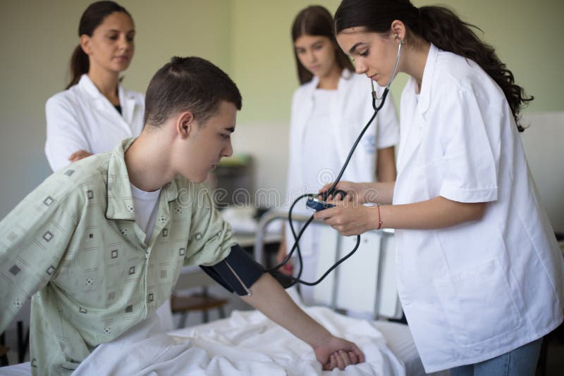 Student in Hospital Measures the Patient`s Pressure Stock Photo - Image ...