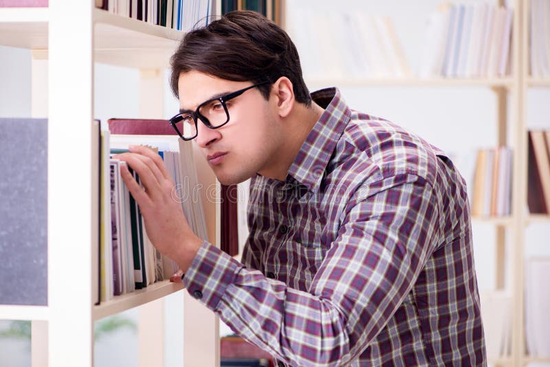 The Young Student Looking for Books in College Library Stock Photo ...