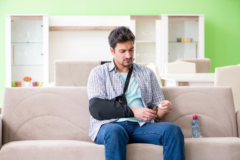 The Young Student Man with Hand Injury Sitting on the Sofa Stock Photo ...