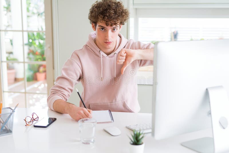 Young Student Man Using Computer and Studying Writing on Notebook with ...