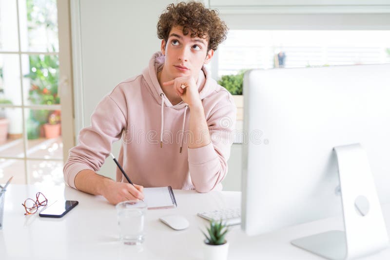 Young Student Man Using Computer and Studying Writing on Notebook ...