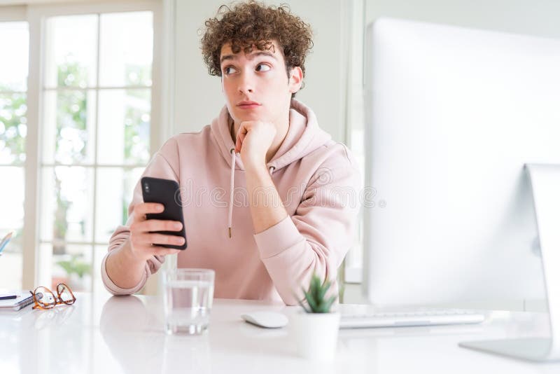Young Student Man Using Smartphone and Computer Serious Face Thinking ...