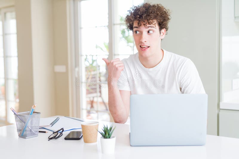 Young Student Man Working and Studying Using Computer Laptop Pointing ...
