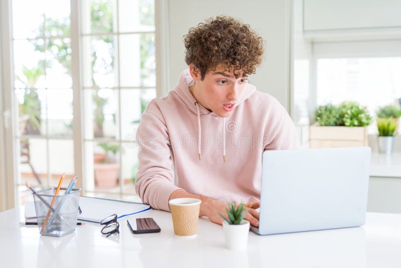 Young Student Man Working and Studying Using Computer Laptop Scared in ...