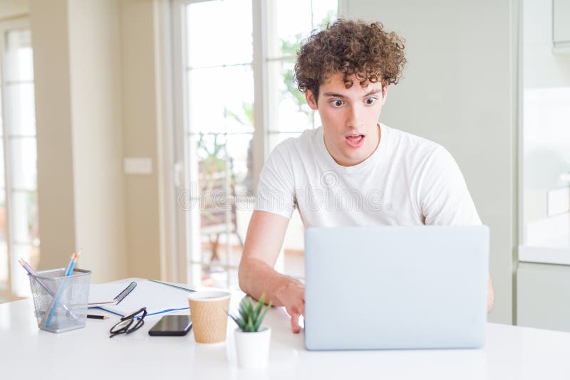 Young Student Man Working and Studying Using Computer Laptop Scared in ...