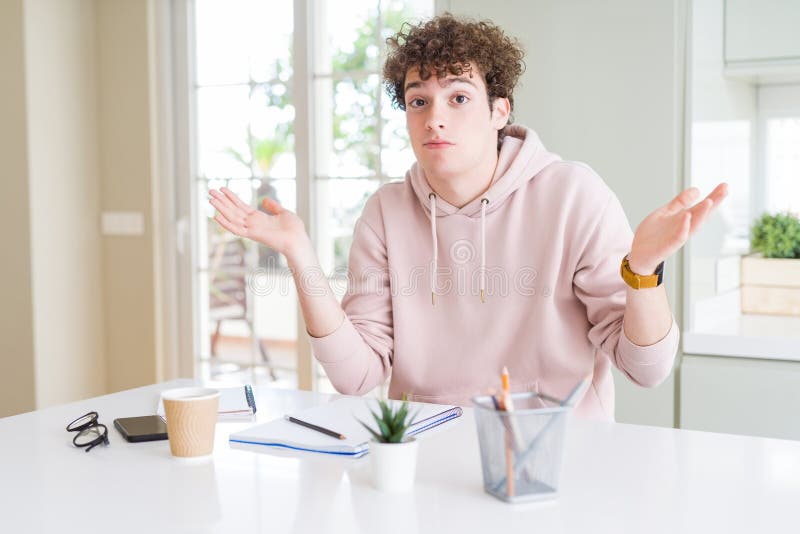 Young Student Man Writing on Notebook and Studying Clueless and ...