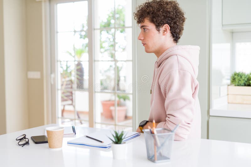 Young Student Man Writing on Notebook and Studying Looking To Side ...