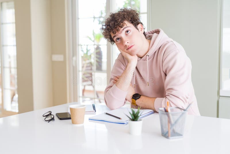 Young Student Man Writing on Notebook and Studying Thinking Looking ...