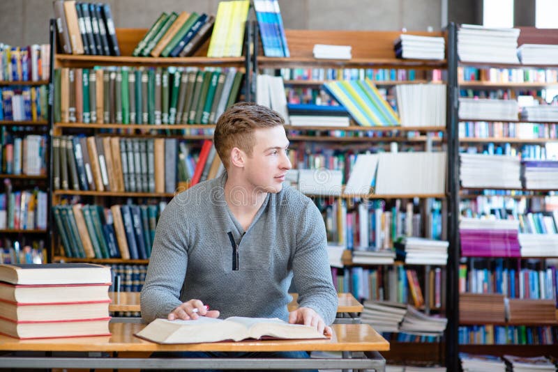 Young Student with Open Book Working in a Library Stock Photo - Image ...