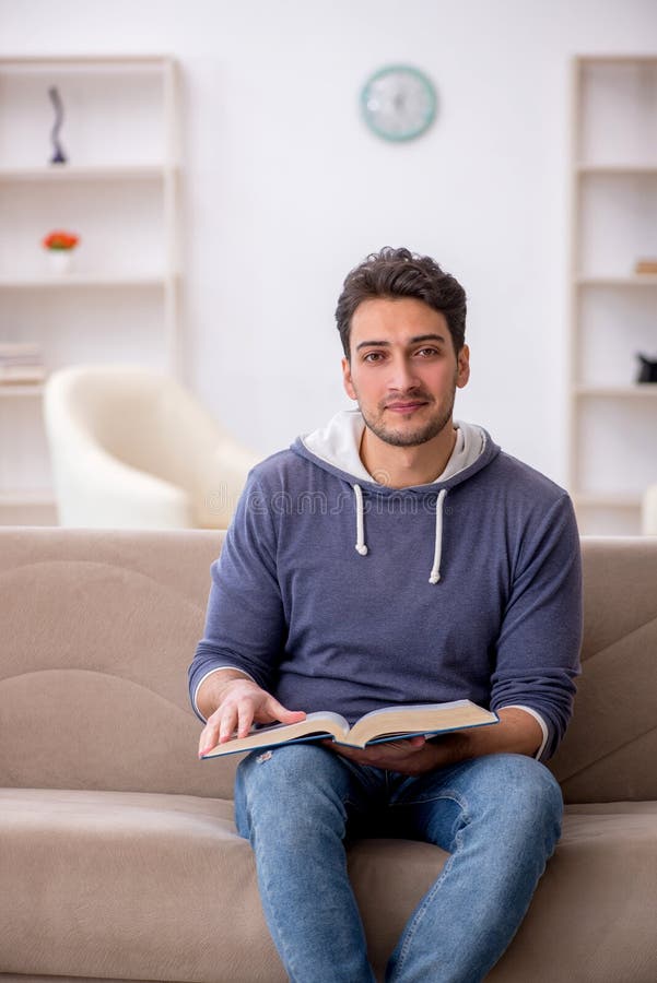 Young Male Student Reading Book at Home Stock Photo - Image of ... Young Male Student Reading Book at Home Stock Photo - Image of ...