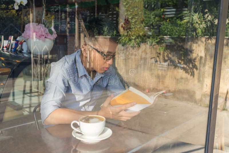 Young Student Reading Book Inside the Coffee Shop Stock Photo - Image ...