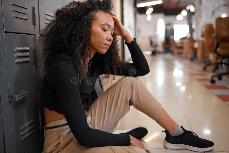 A Young Student Sits Alone in the School Corridor Looking Unhappy and ...