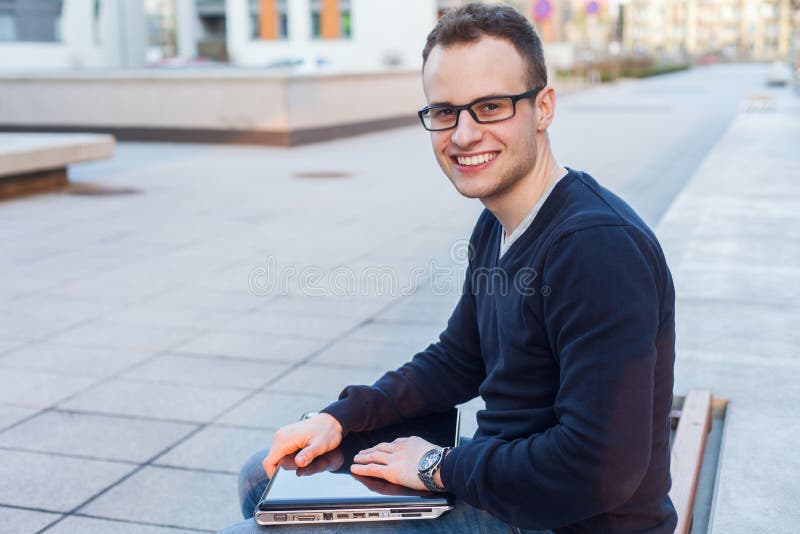 Young Student Sitting on a Bench with Laptop Computer. Stock Image ...
