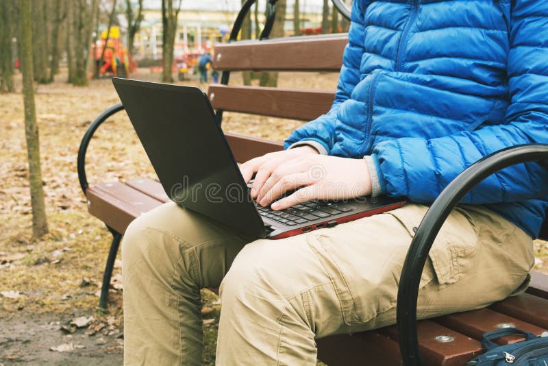 Young Student Sitting on Bench with Laptop in Park Stock Image - Image ...