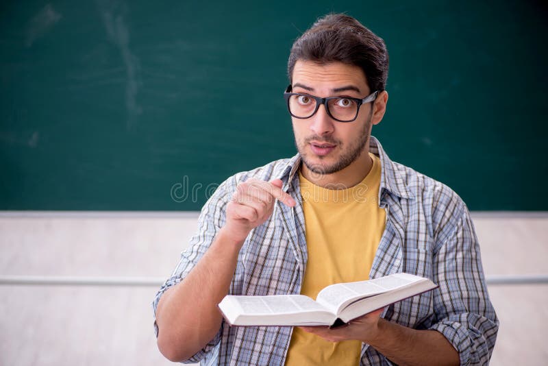 Young Male Student Sitting in the Classroom Stock Photo - Image of book ...