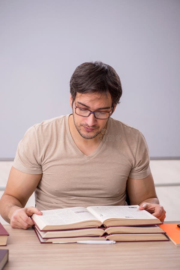 Young Male Student Sitting in the Classroom Stock Photo - Image of ... Young Male Student Sitting in the Classroom Stock Photo - Image of ...