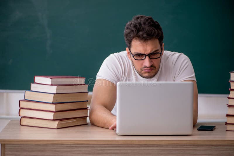 Young Male Student Sitting in the Classroom Stock Photo - Image of pile ... Young Male Student Sitting in the Classroom Stock Photo - Image of pile ...