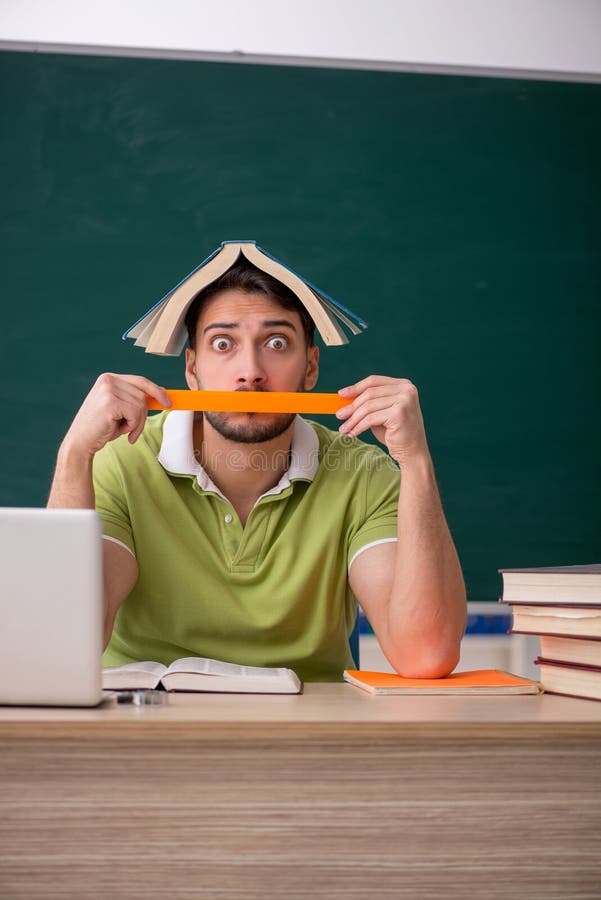 Young Male Student Sitting in Front of Green Board Stock Photo - Image ...