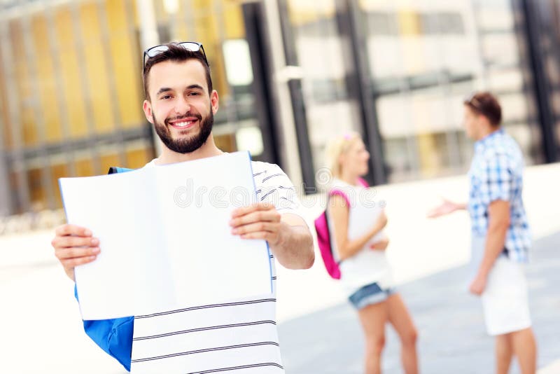 Young Student Standing in the Campus with an Open Notebook Stock Image ...