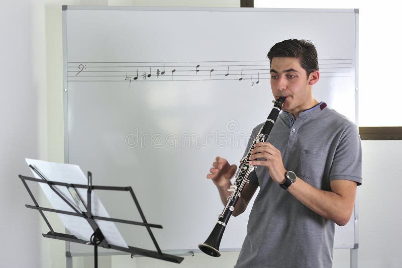 Young Student Studies Lesson on Sheet Music in the Classroom. Stock ...