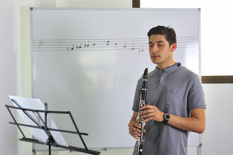 Young Student Studies Lesson on Sheet Music in the Classroom. Stock ...