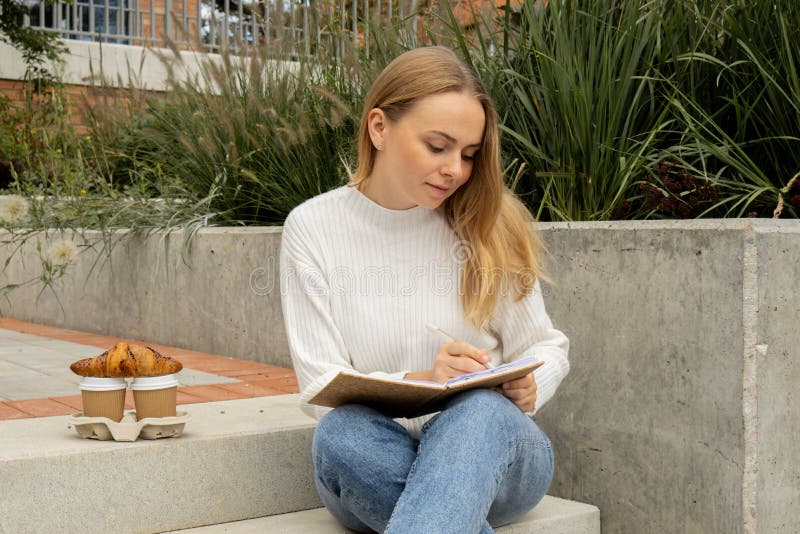 Young Student Study with Notebook in Park. Drinking Coffee and Eat ...