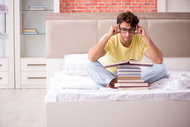 The Young Student Studying in Bed for Exams Stock Photo - Image of ...