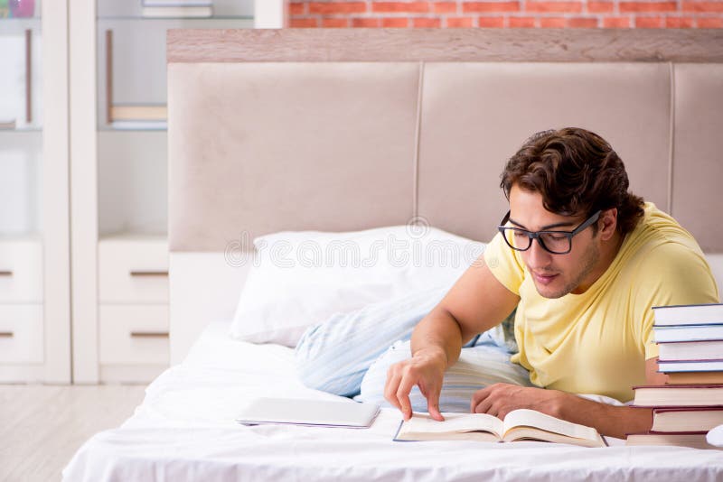 The Young Student Studying in Bed for Exams Stock Photo - Image of ...