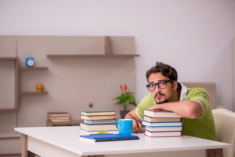 Young Male Student Studying at Home Stock Photo - Image of books ...