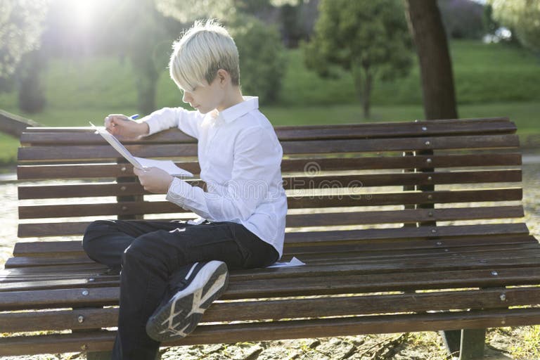 Young Student Studying Outdoors Taking Notes on Park Bench Stock Image ...