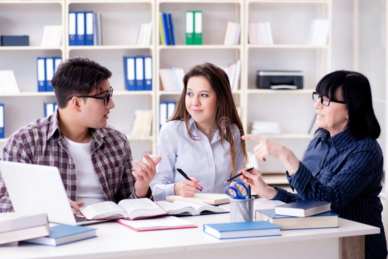 Teacher tutoring students stock image. Image of pretty - 27195083