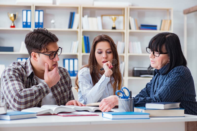 Teacher tutoring students stock image. Image of pretty - 27195083