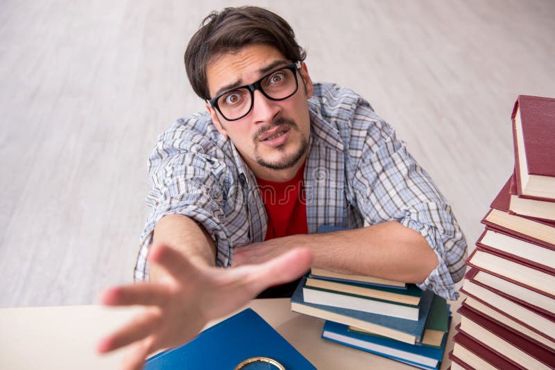 Young Male Student and Too Many Books in the Classroom Stock Image ...