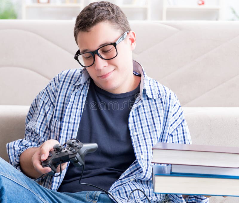 Young Student Trying To Balance Studying and Playing Games Stock Image ...