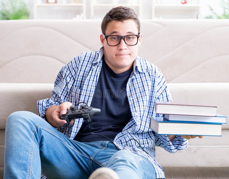 Young Student Trying To Balance Studying and Playing Games Stock Image ...