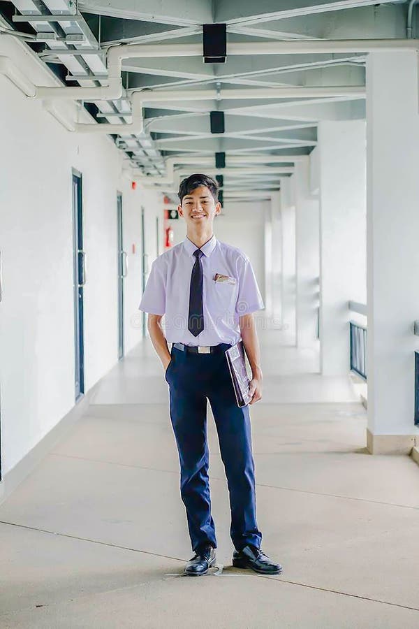 Young Student with Uniform Standing in Front of the Classroom Stock ...