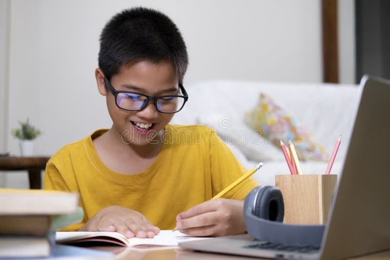 Young Student Using Computer and Mobile Device Studying Online Stock ...