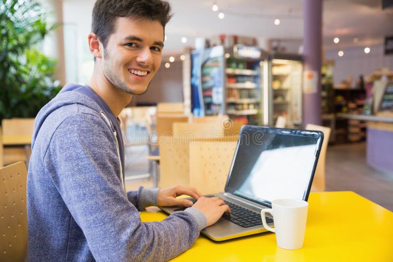 Young Student Using His Laptop in Cafe Stock Photo - Image of laptop ...