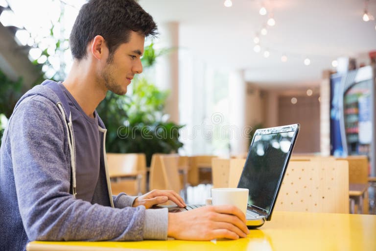 Young Student Using His Laptop in Cafe Stock Photo - Image of male ...