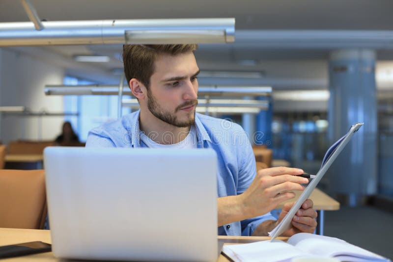 Young Student Working on Laptop in Library Stock Photo - Image of male ...