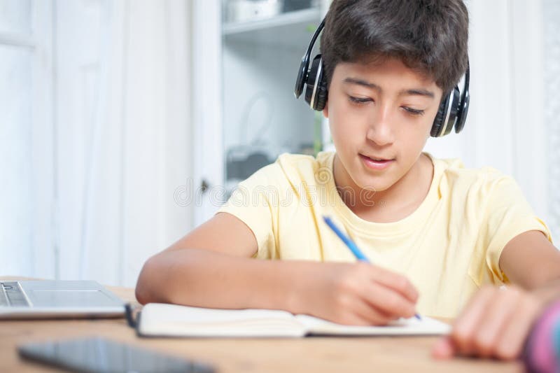 Young Student Writing with a Pen on a Notepad on a Desk. Stock Image ...