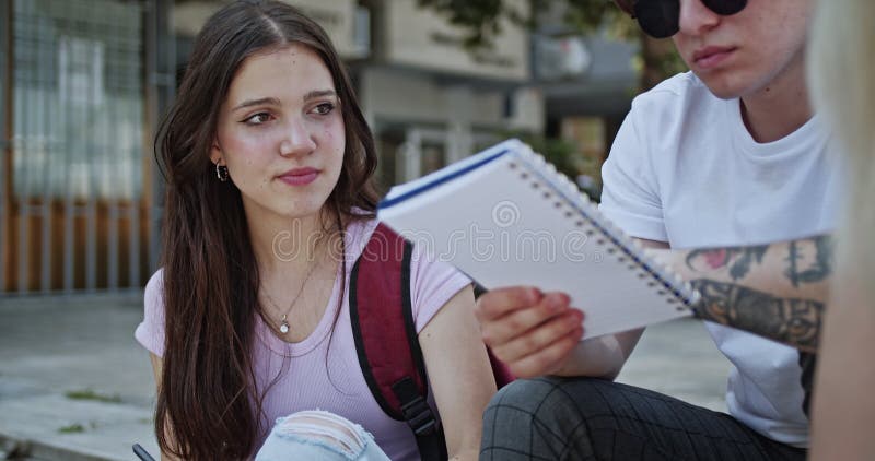 Young Students Collaborate on Outdoor Study Session, Sharing Knowledge ...